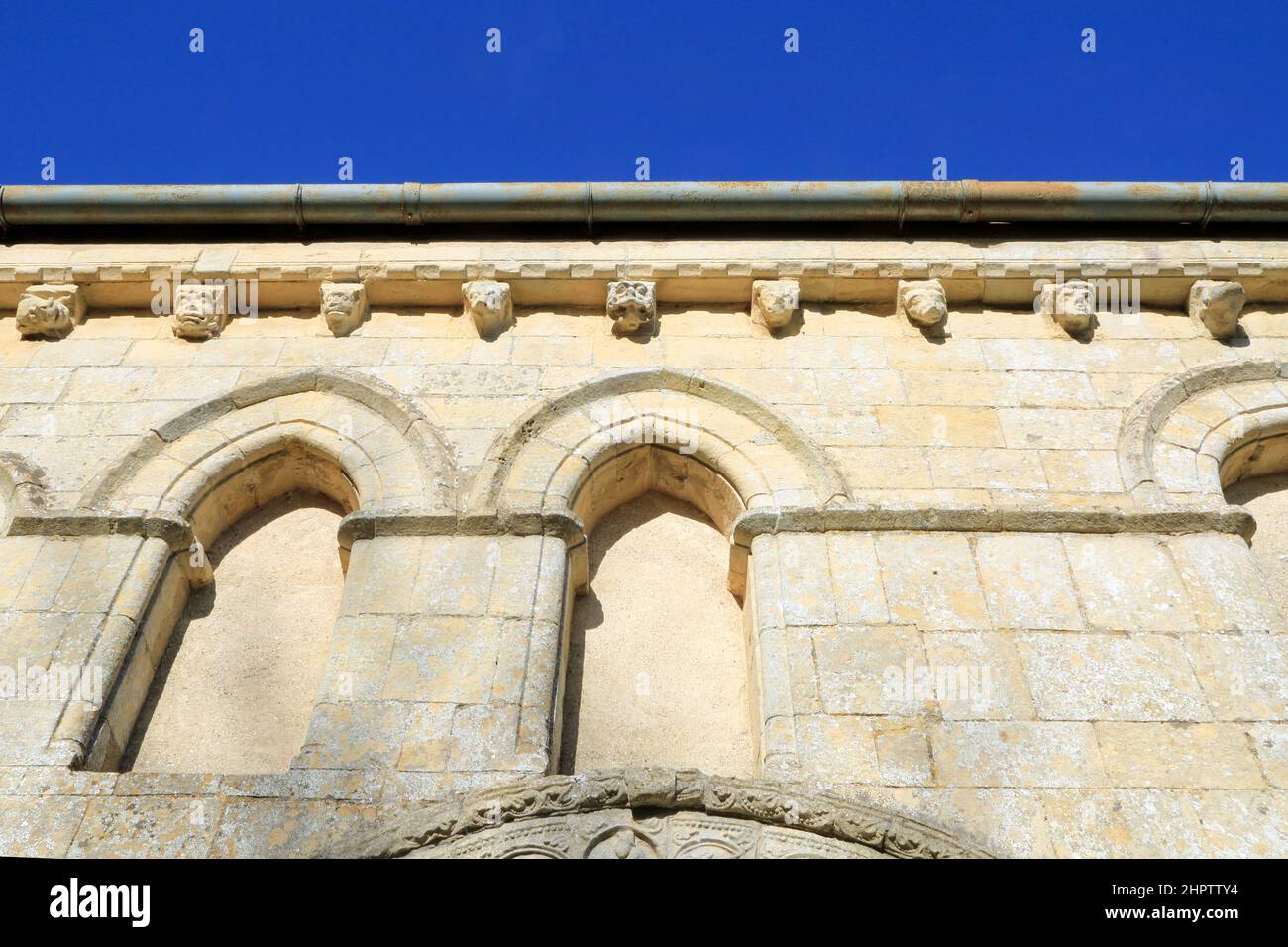 Roofline and stone carvings on St Nicholas church - Norman architecture ...