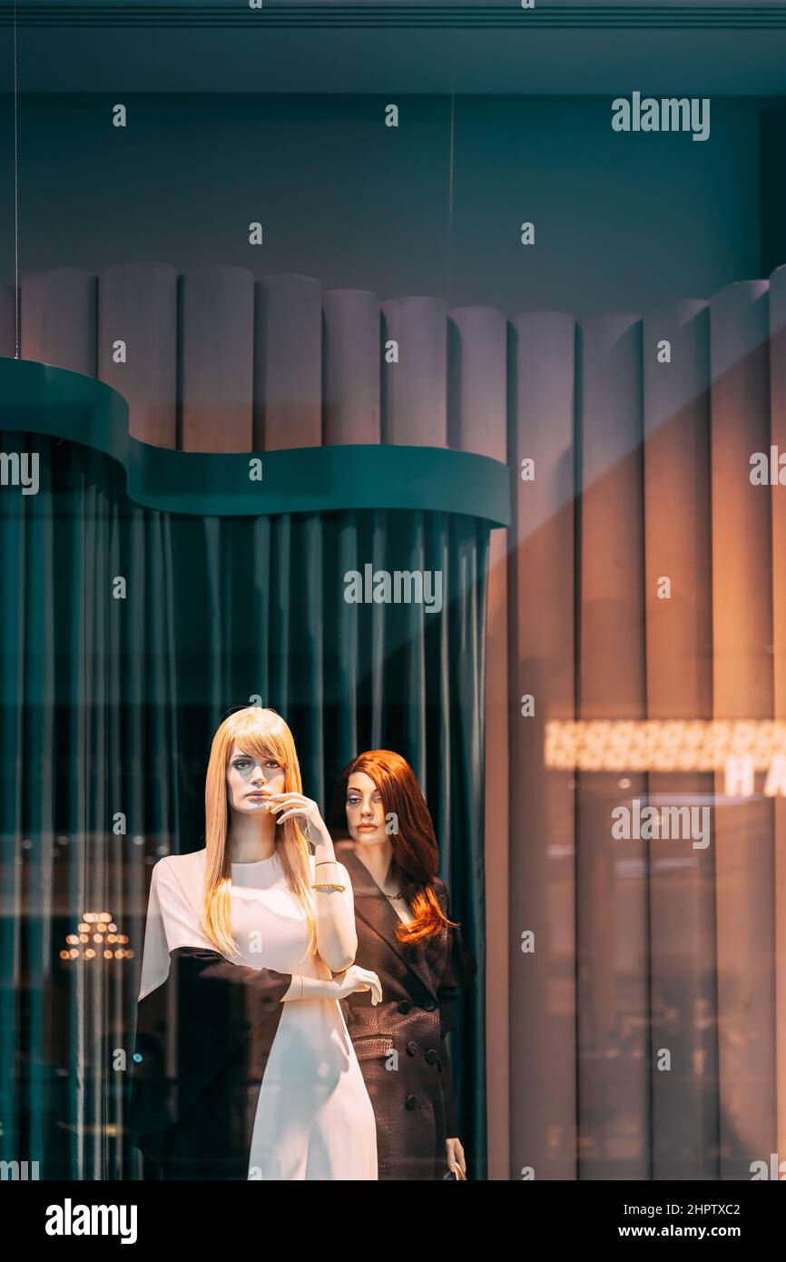 Female mannequin in shop window showcase of store mall market. Fashion ...