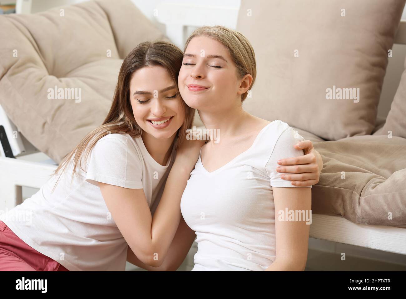 Young sisters spending time together at home Stock Photo - Alamy