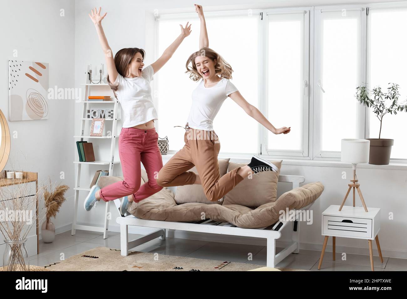 Happy young sisters having fun at home Stock Photo - Alamy