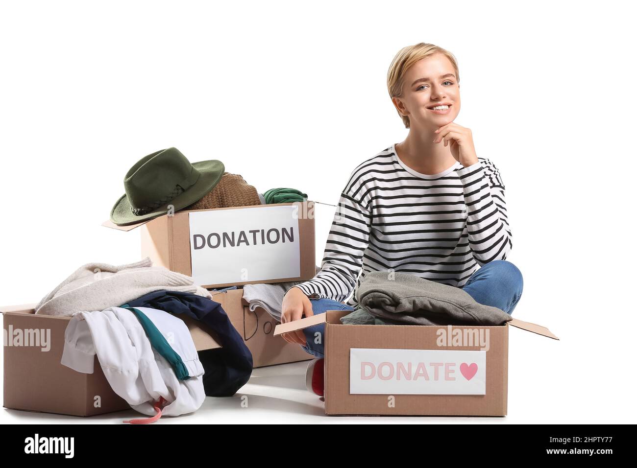 Young woman with donation clothes and boxes on white background Stock ...