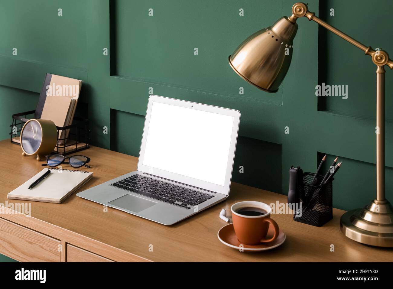 Modern workplace with laptop in room Stock Photo - Alamy