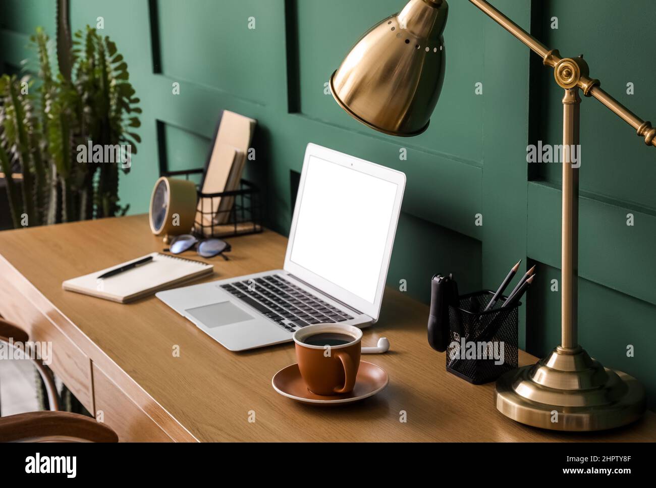 Modern workplace with laptop in room Stock Photo - Alamy