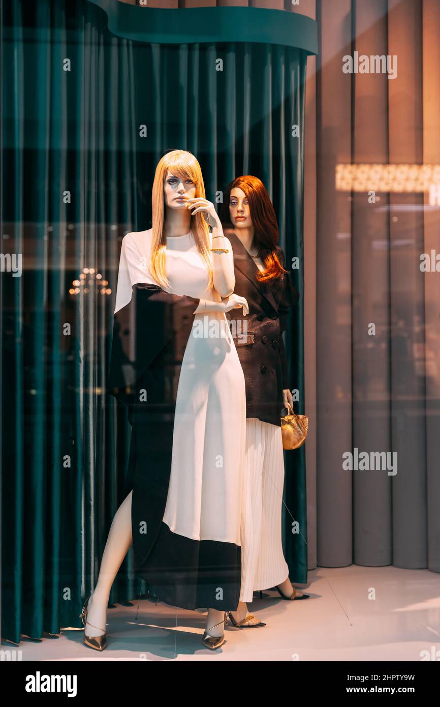 Female mannequin in shop window showcase of store mall market. Fashion ...
