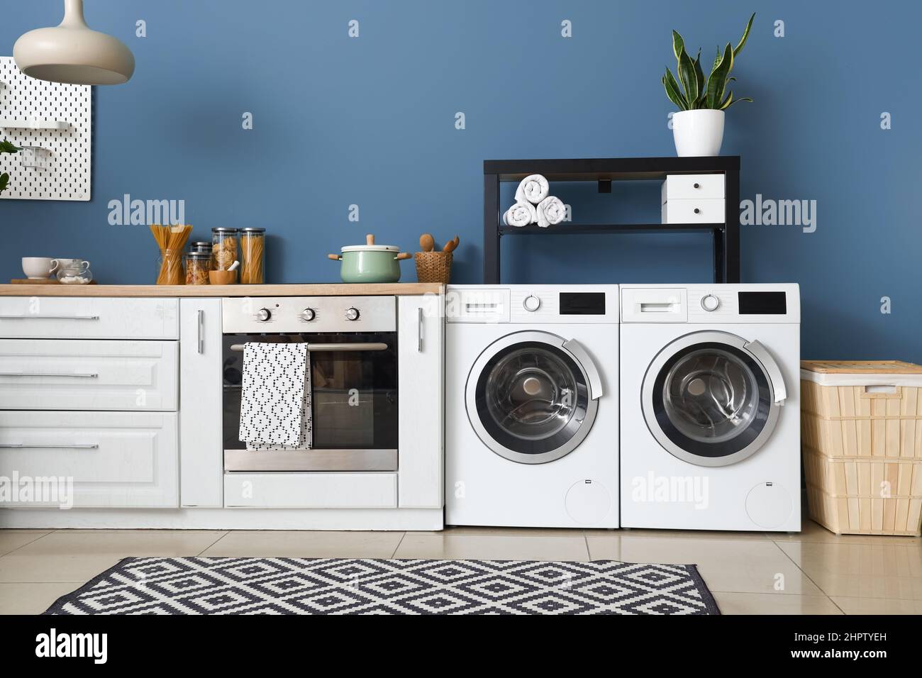 Interior of stylish kitchen with modern washing machines and oven Stock ...
