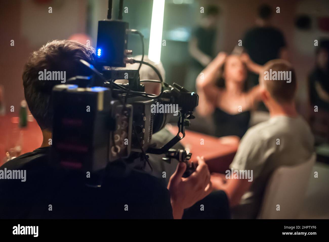 Behind the scenes. Cameraman shooting the film scene with camera on ...