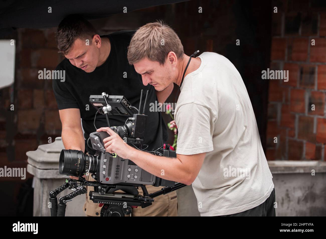 Behind the scenes. Cameraman shooting the film scene with camera on ...