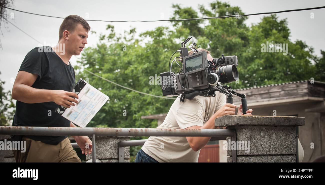 Behind the scenes. Cameraman shooting the film scene with camera on ...