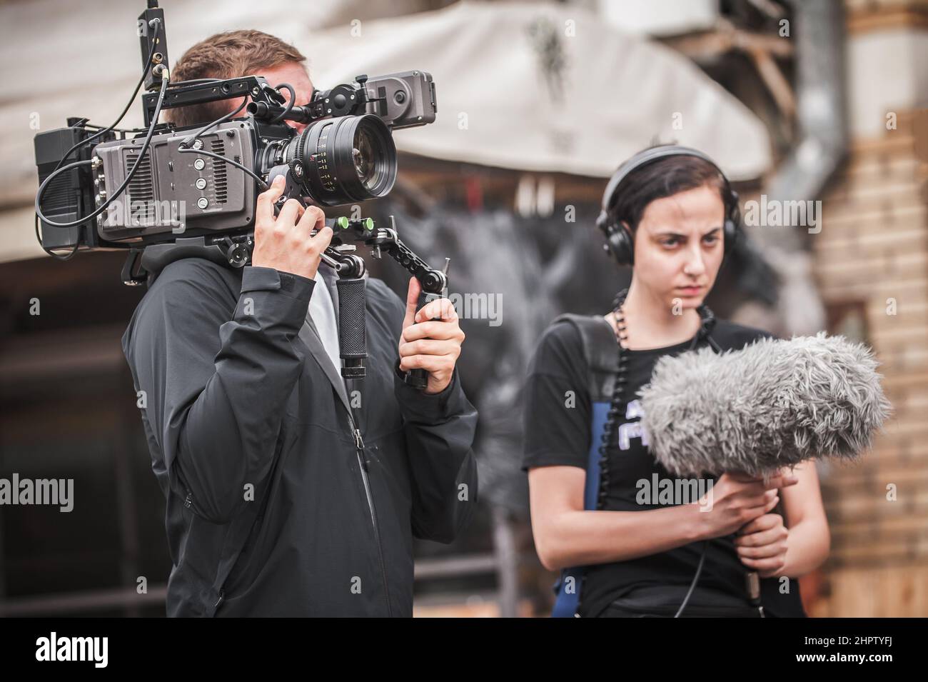 Behind the scenes. Cameraman shooting the film scene with camera on ...