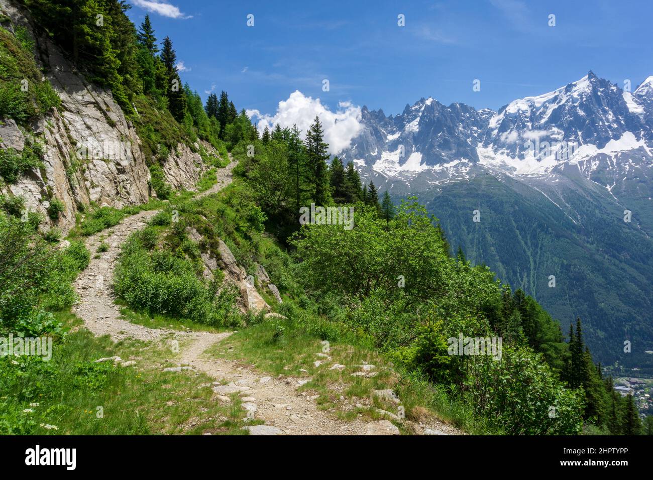 Mountain hiking trail in the Alps with a view of the Mont Blanc massif ...
