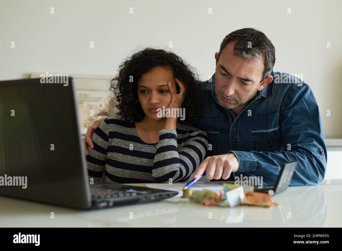 interracial couple managing consumer bills at home Stock Photo - Alamy
