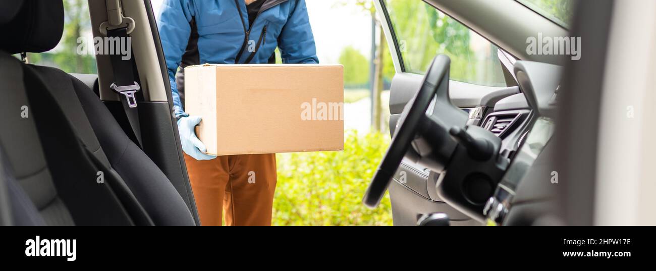 Delivery driver driving with parcels on seat Stock Photo - Alamy