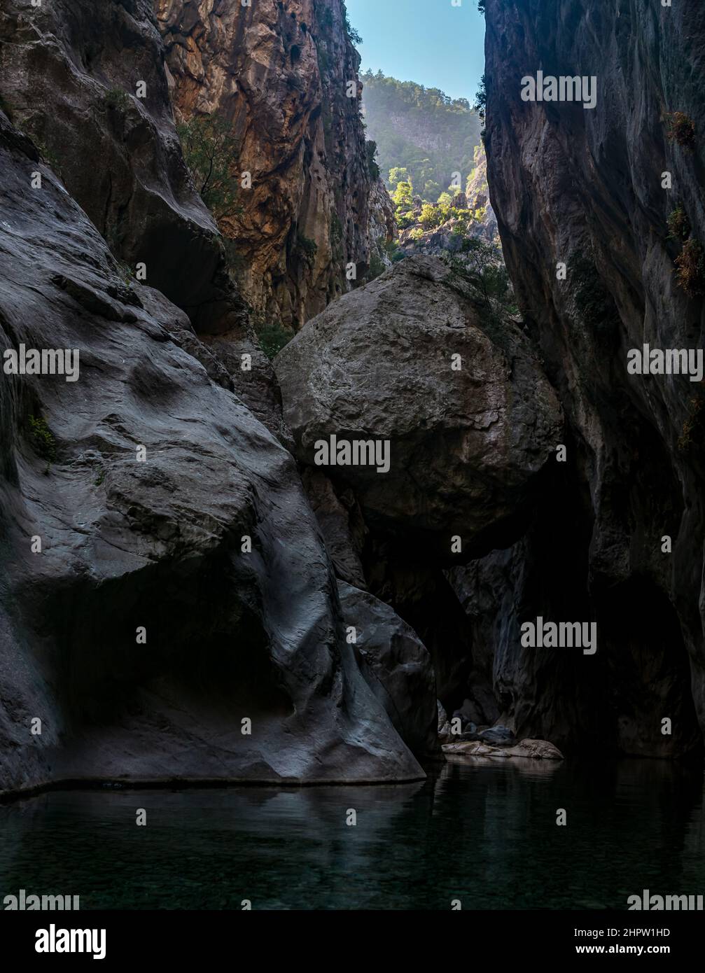huge stone hangs stuck between two rocky walls of the Göynük canyon in ...