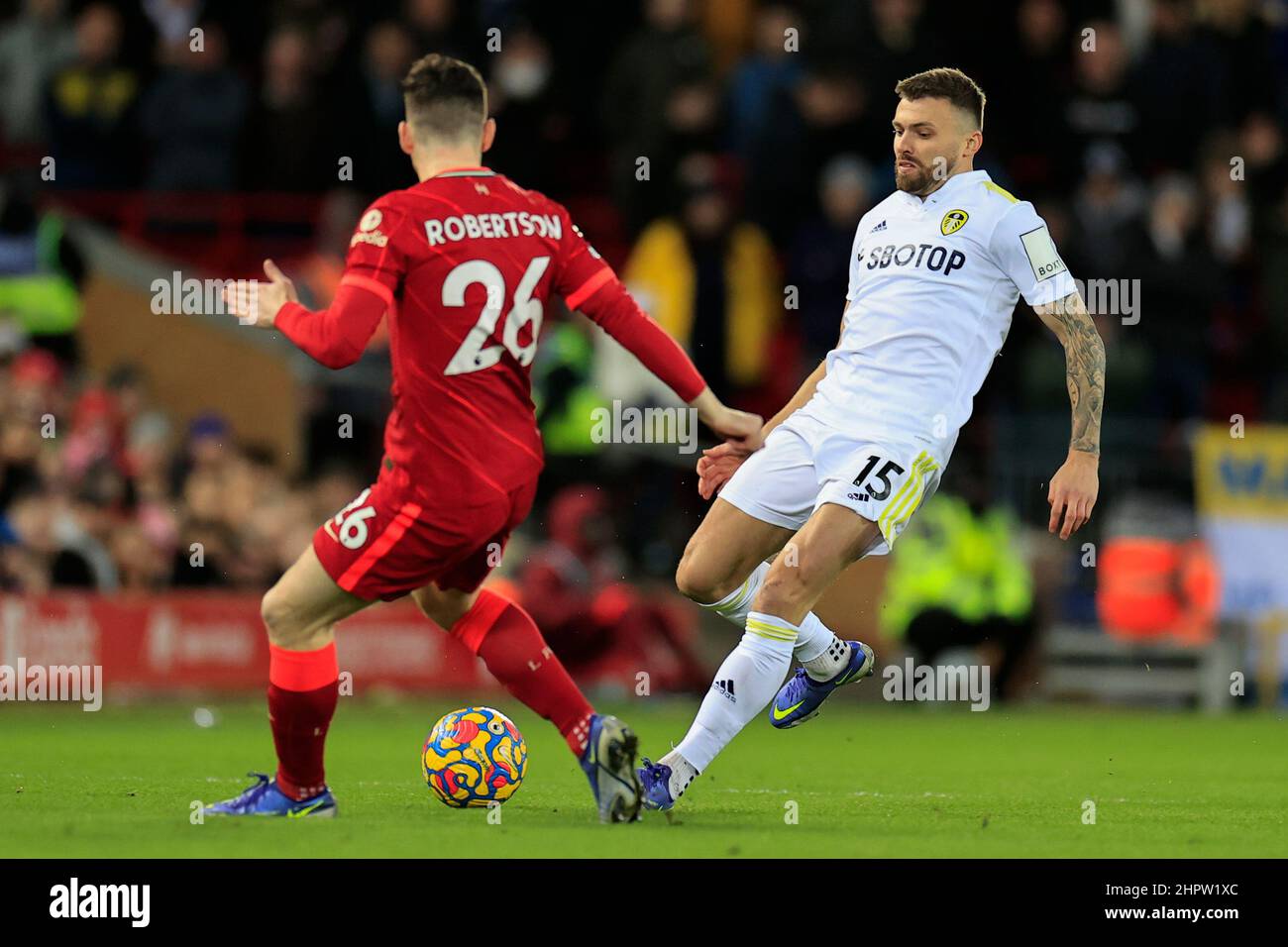 Stuart Dallas #15 of Leeds United is confronted by Andrew Robertson #26 ...