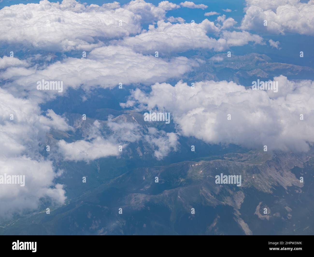 Aerial view of mountain landscape, view from window seat in an airplane ...