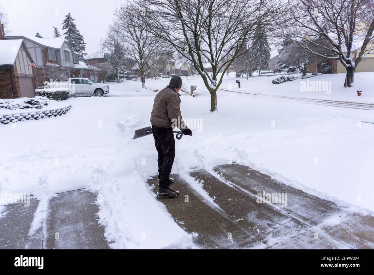 Retiree clearing driveway after winter snow storm Stock Photo - Alamy