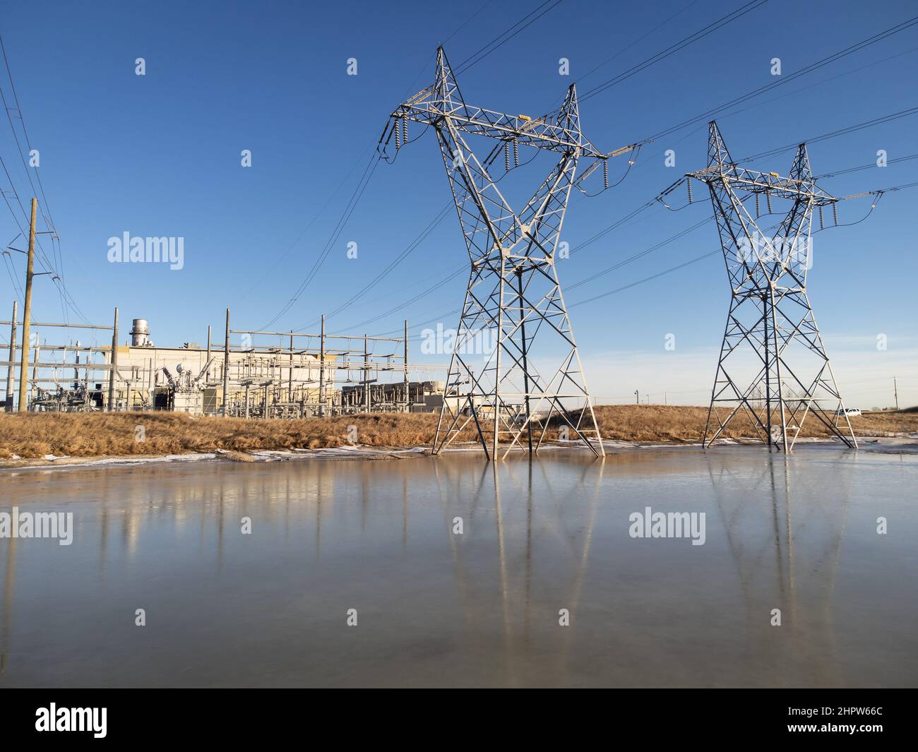 Large transmission towers with power lines and a natural gas plant ...