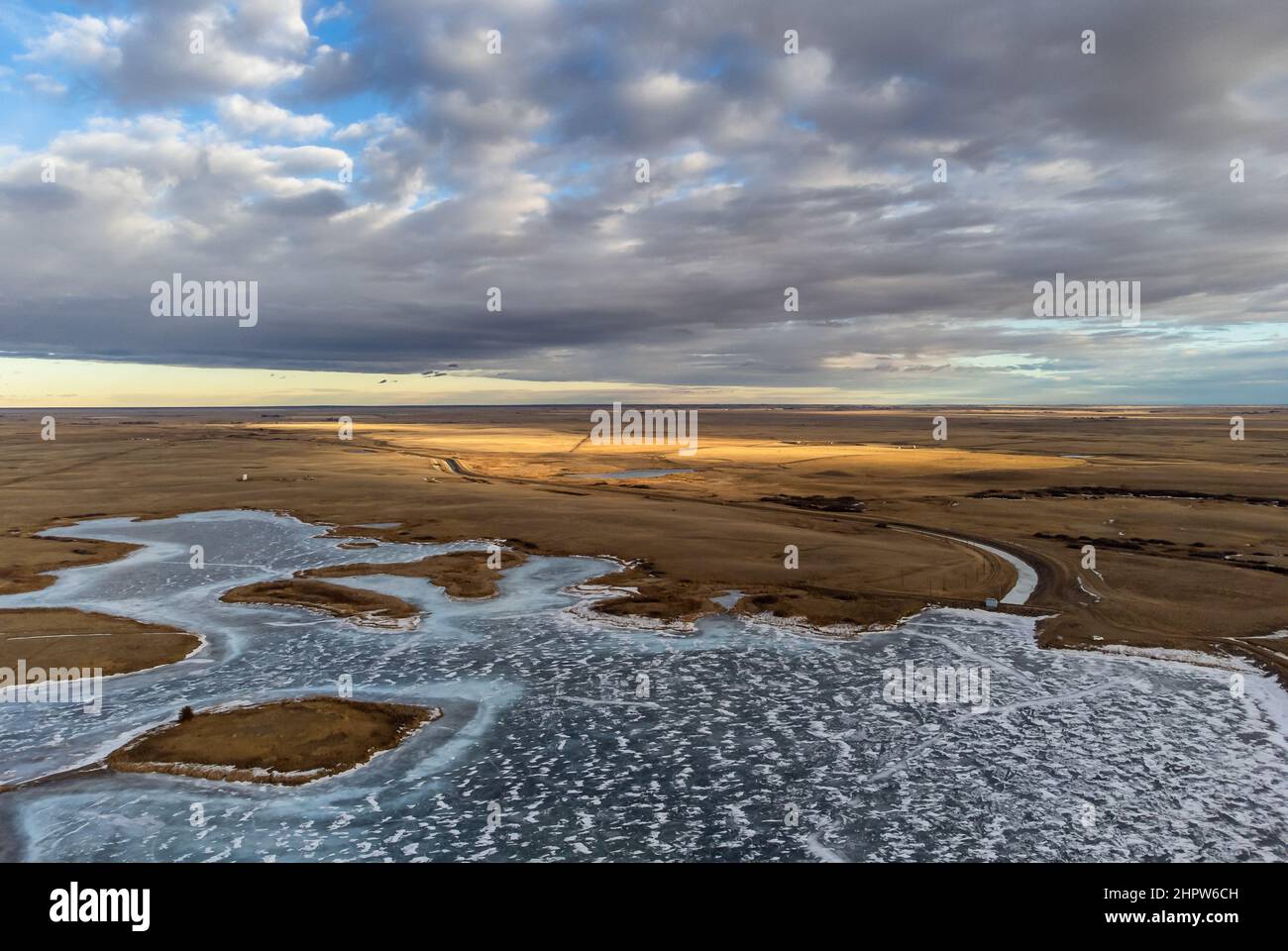 Aerial view of large cracks across Crawling Valley Reservoir and frozen ...