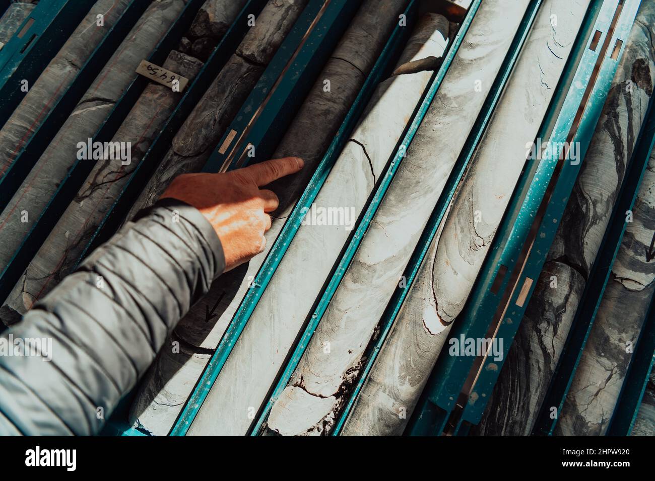 Geological gold core samples with team of mining workers measuring ...