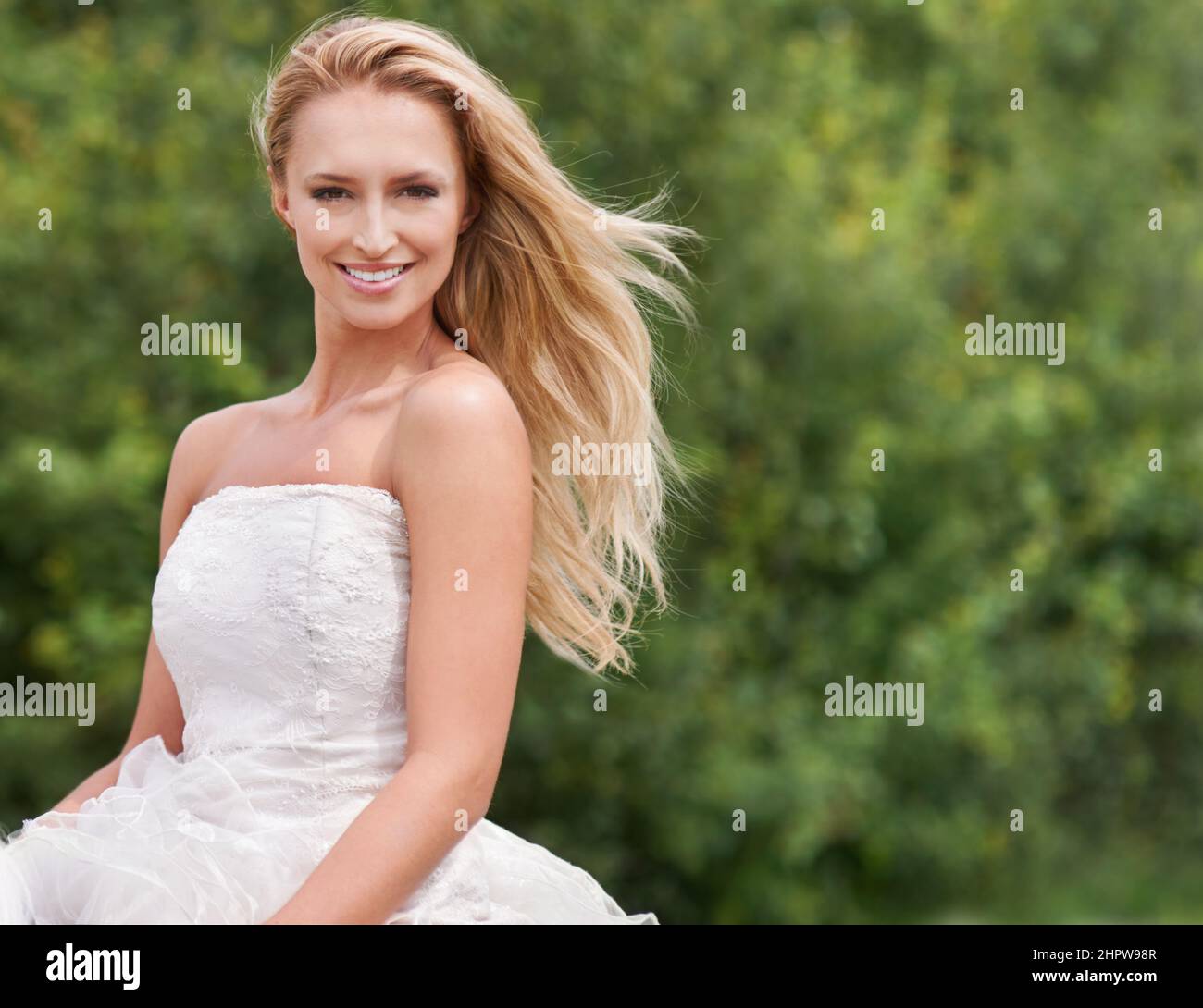 Stunning on her big day. A gorgeous young bride smiling and looking ...