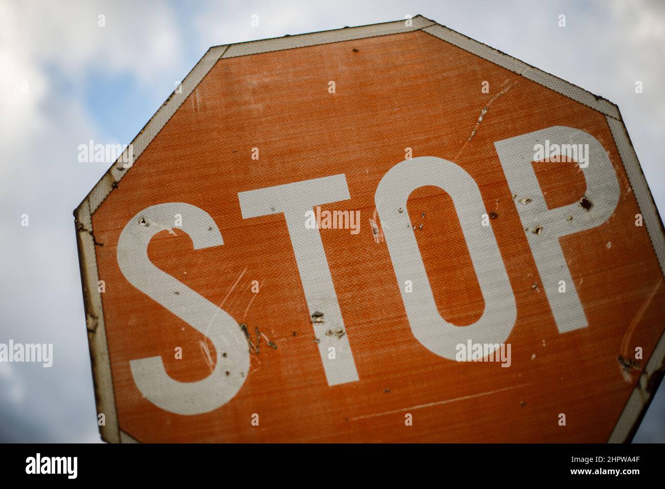 Close up shot of a stop sign on a cloudy sky background Stock Photo - Alamy