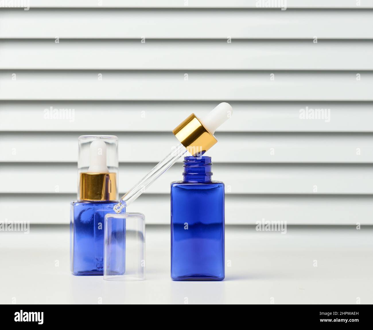 blue glass bottle with a pipette on a white background. Template for ...