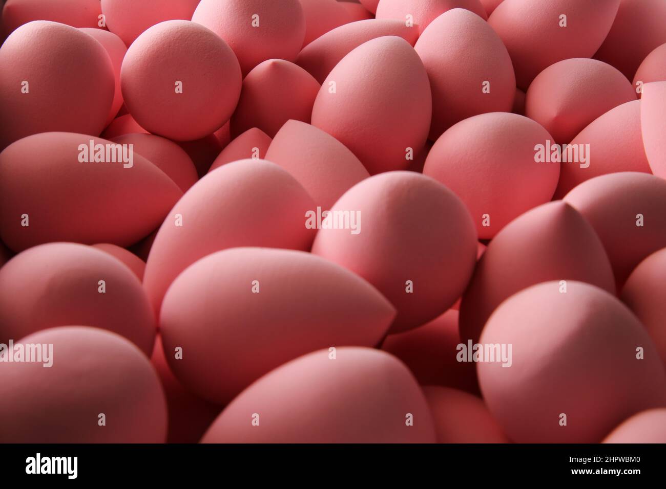 beauty background a bunch of pink gentle makeup sponges vertical ...