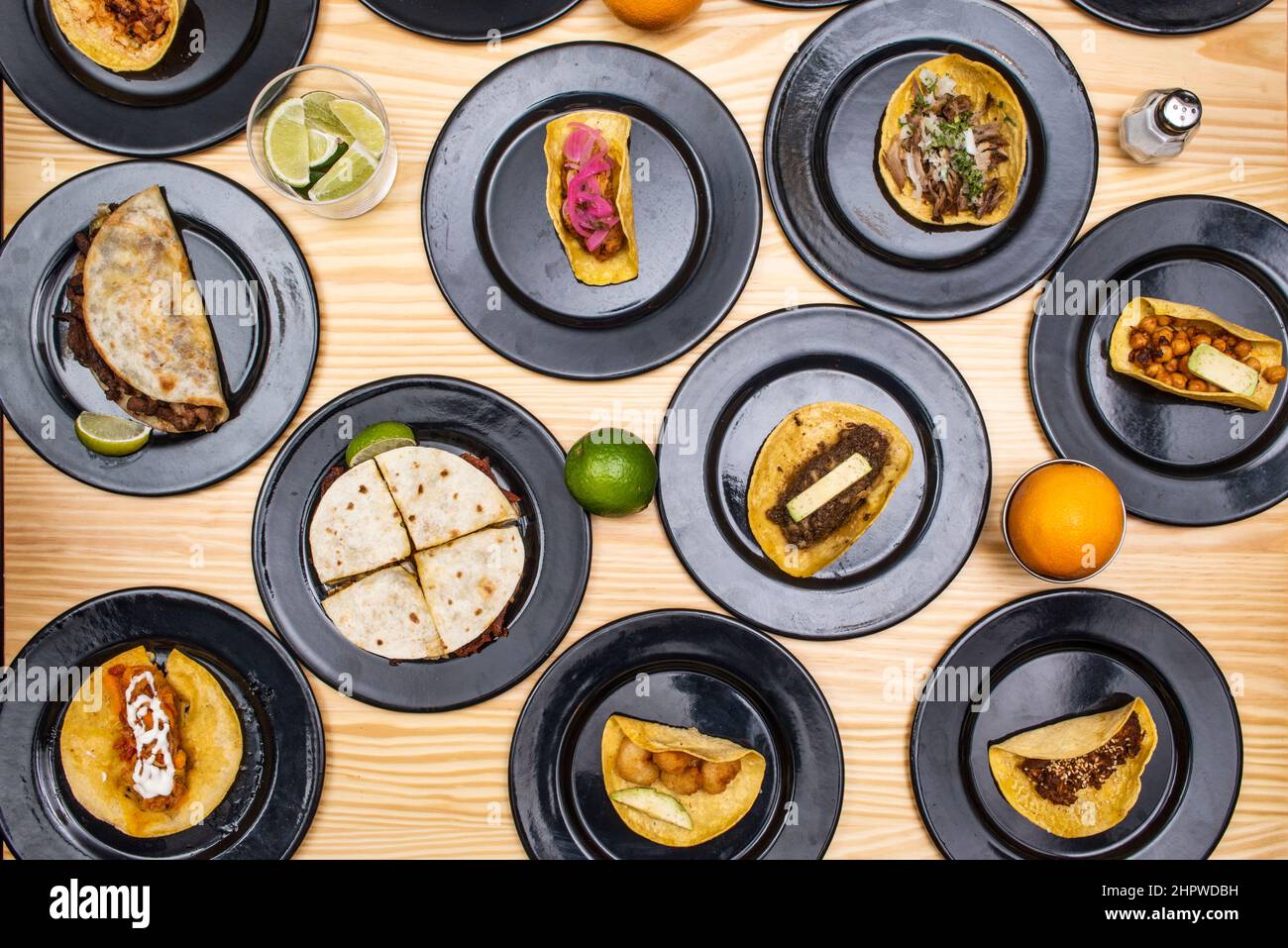 Top view image of black plates with synchronized quesadillas, assorted ...