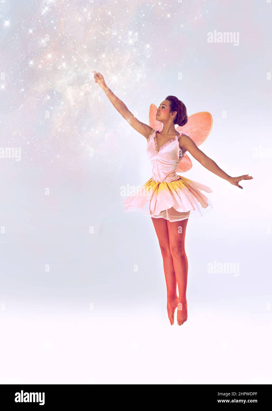 Bringing the magic. A full length shot of a cute fairy casting a spell ...