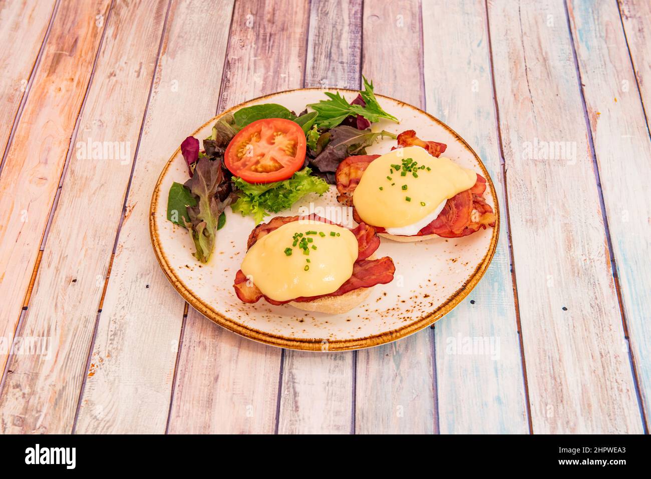 Eggs Benedict, consists of two halves of an English muffin, toast or ...