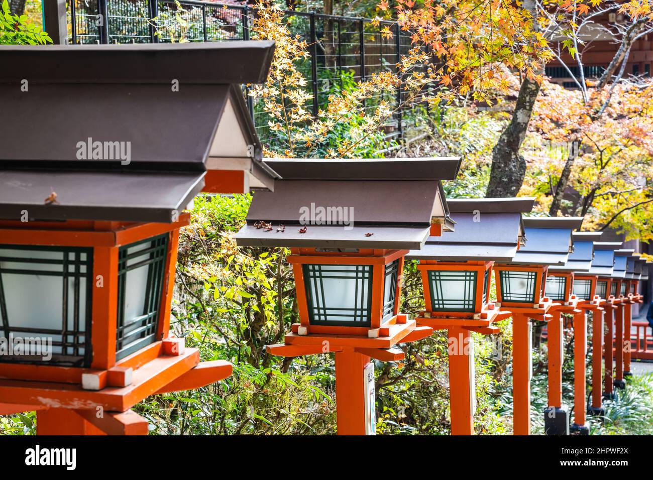 A traditional Japanese style wooden lamp post with hints of fall color ...