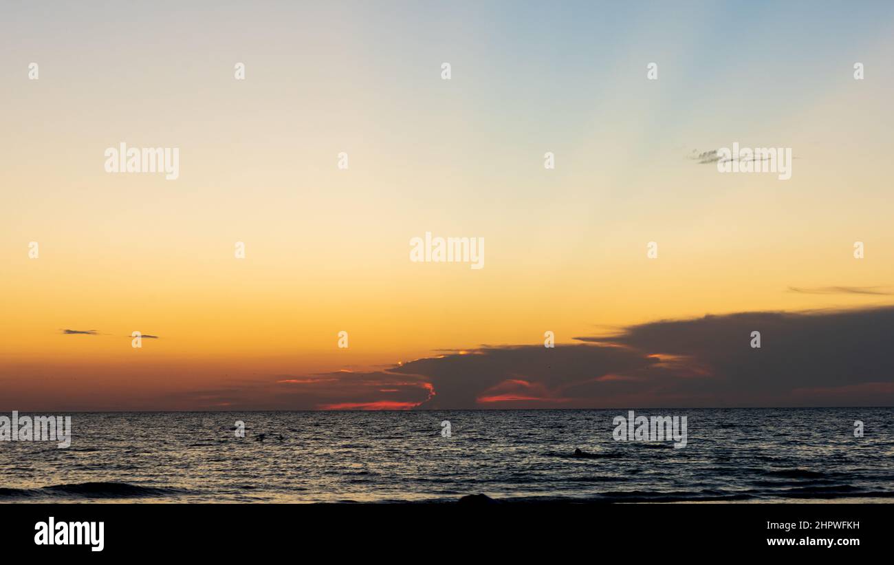 Epic sunset sky with rays of light from horizon above ocean Stock Photo ...