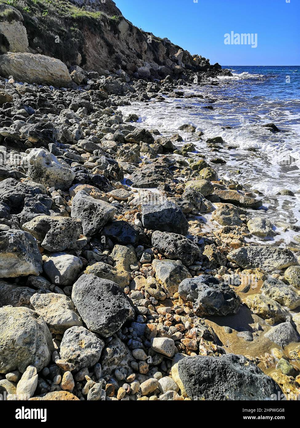 Beautiful view of the wavy sea hitting the rocky beach Stock Photo - Alamy