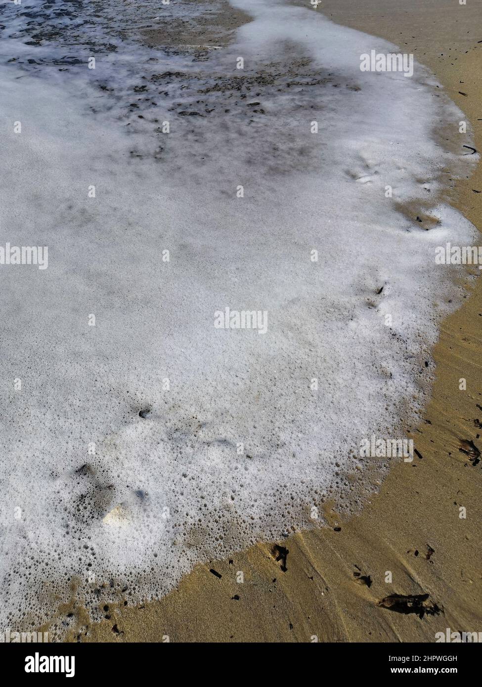 Beautiful view of the wavy sea hitting the sandy beach Stock Photo - Alamy