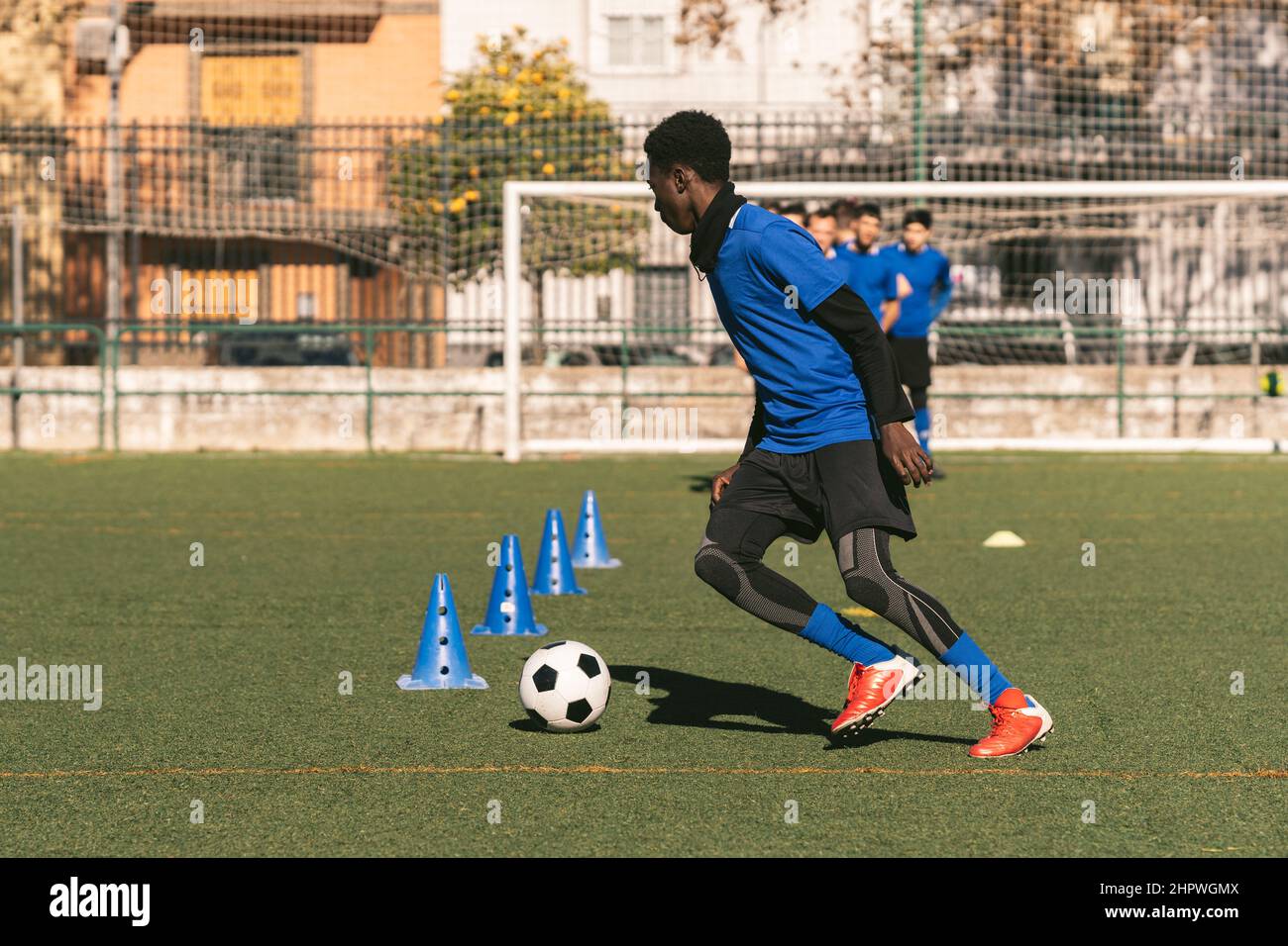 young black player turns to the right controlling a football ball Stock ...