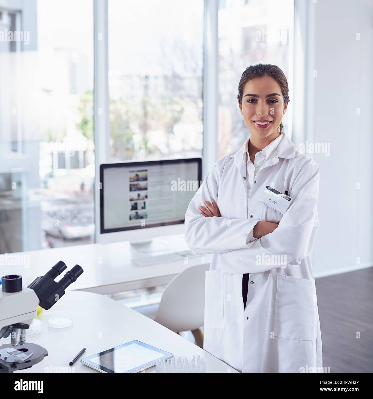 Advancing medical science. Portrait of a confident young female scientist standing with arms ...