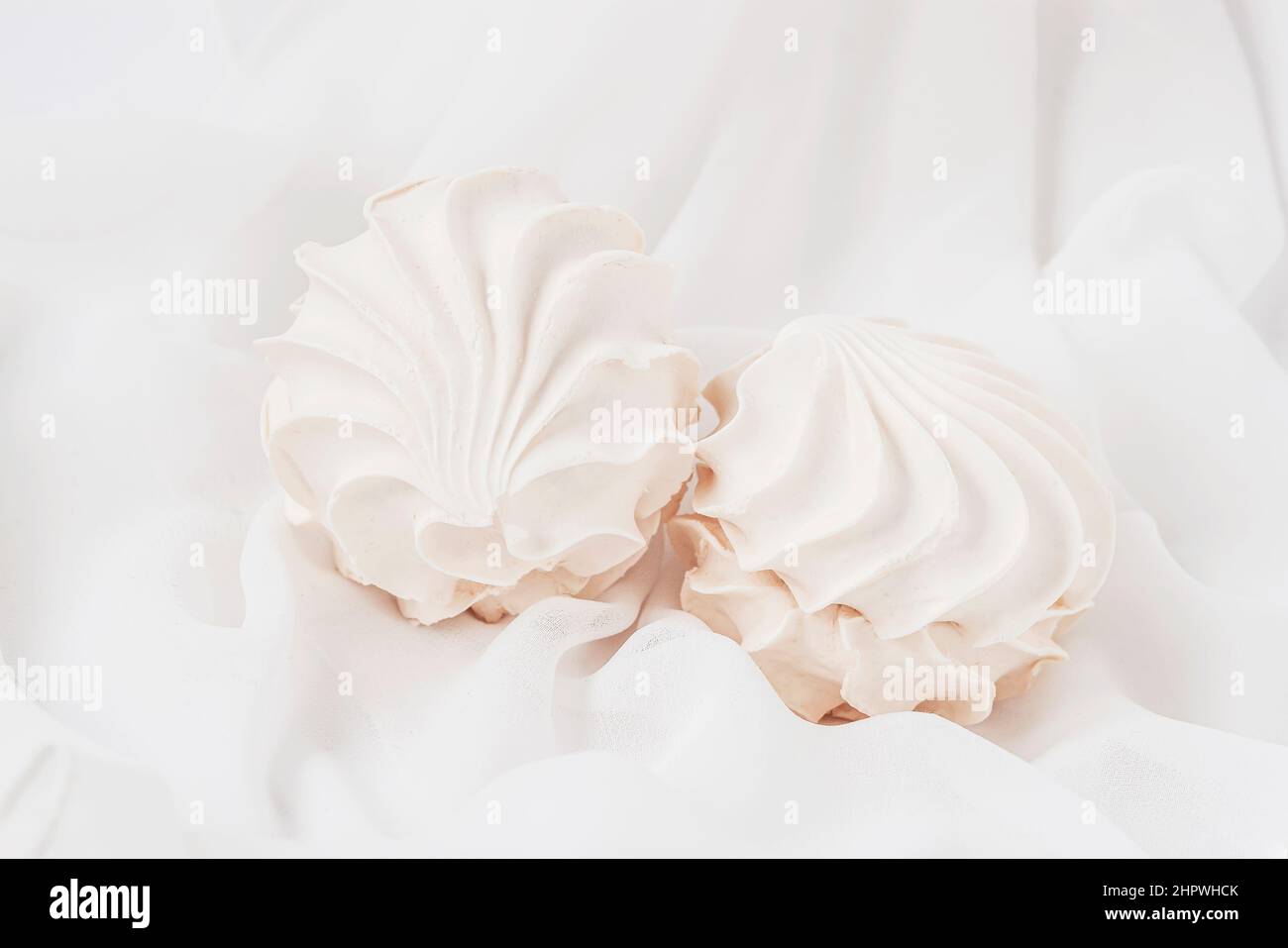 Two delicious sweet white zephyr marshmallows closeup on white ...