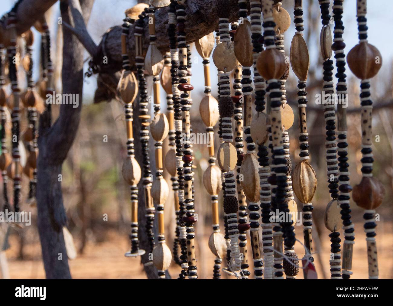 Close up of strings of African necklaces made from beads and seeds on ...
