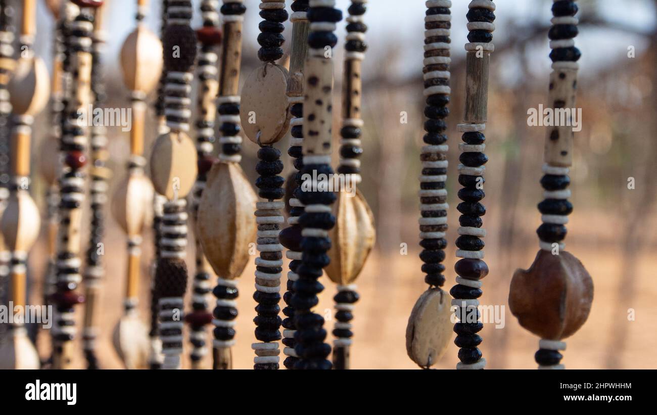 Close up of strings of African necklaces made from beads and seeds on ...