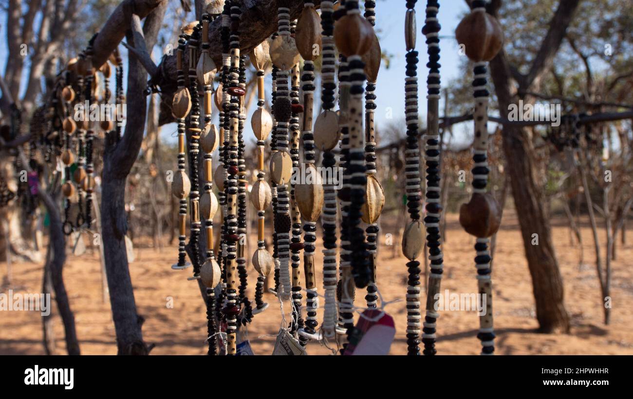 Close up of strings of African necklaces made from beads and seeds on ...