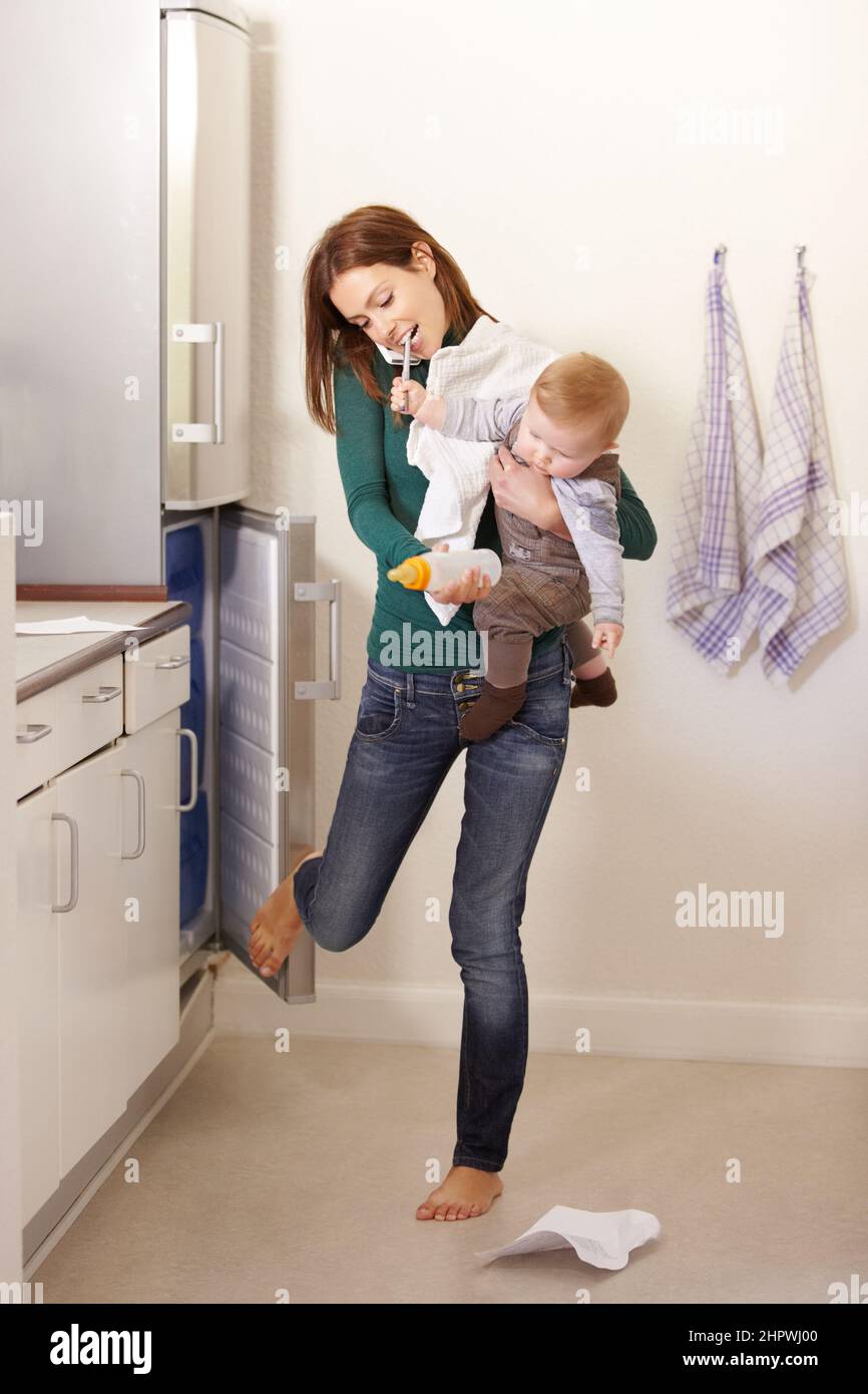 Being Mom Is A Balancing Act Young Mom Trying To Multi Task On The