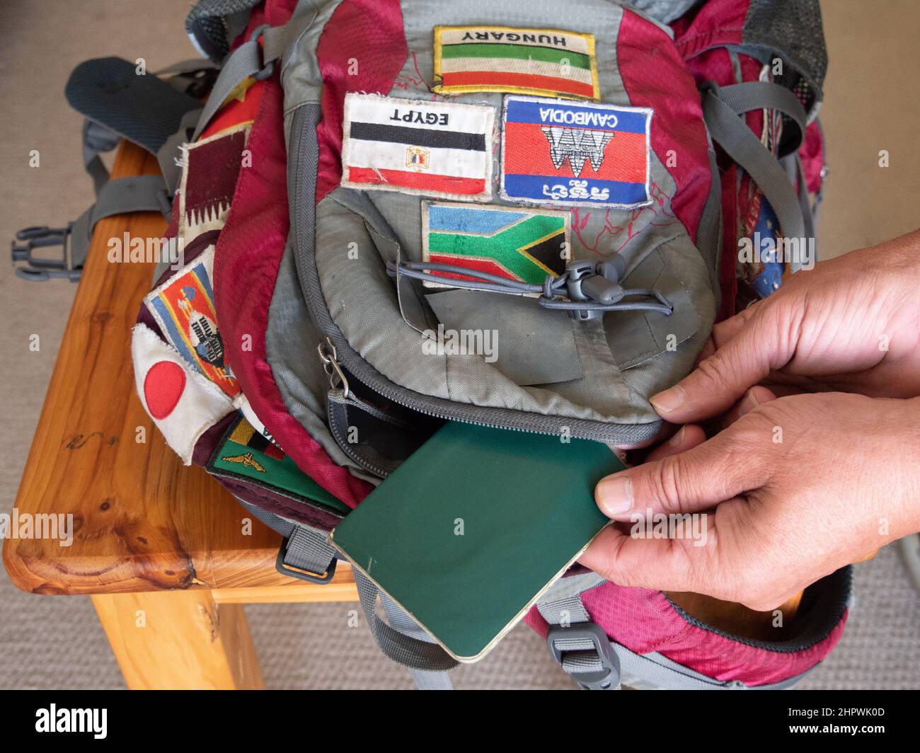 Getting ready to travel, packing passport into backpack which is ...