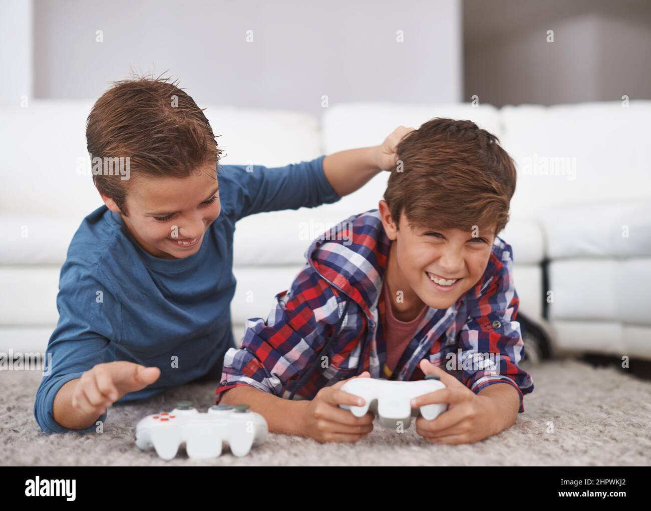 You always beat me. Shot of two young boys teasing each other while ...