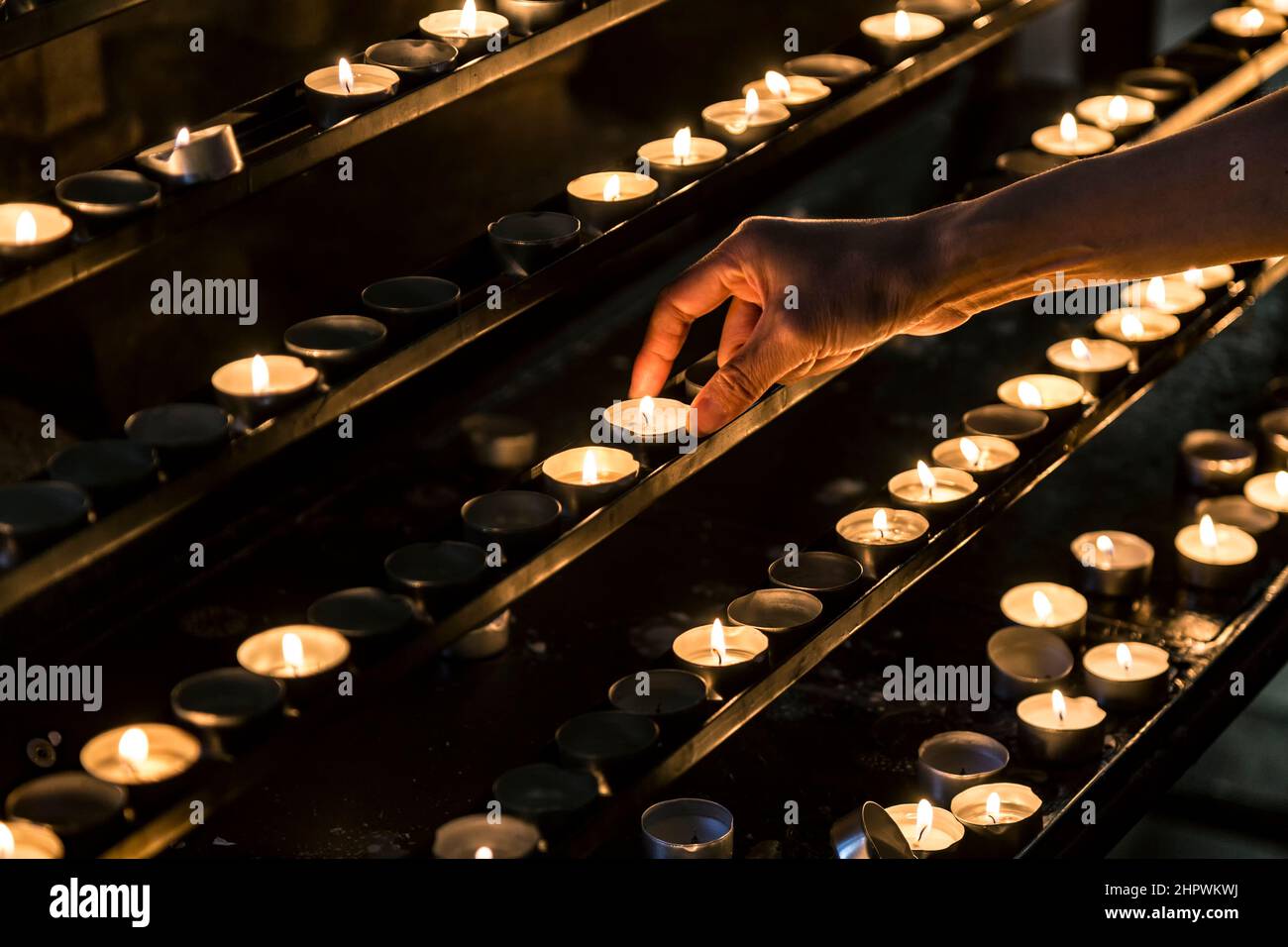 Candle woman putting hi-res stock photography and images - Alamy