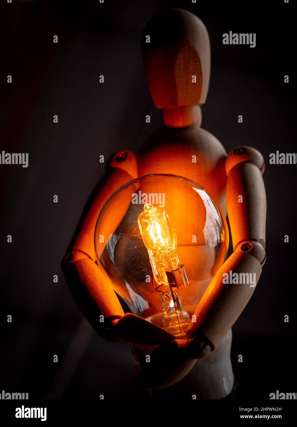 Still life, wooden figure with halogen lamp, symbol photo energy ...
