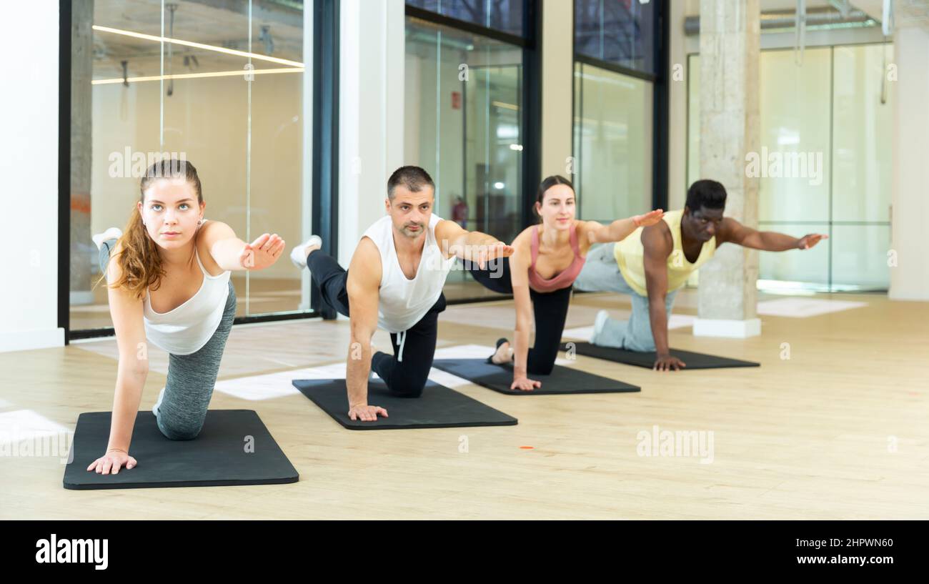 Young adults exercising during pilates class in fitness center Stock ...