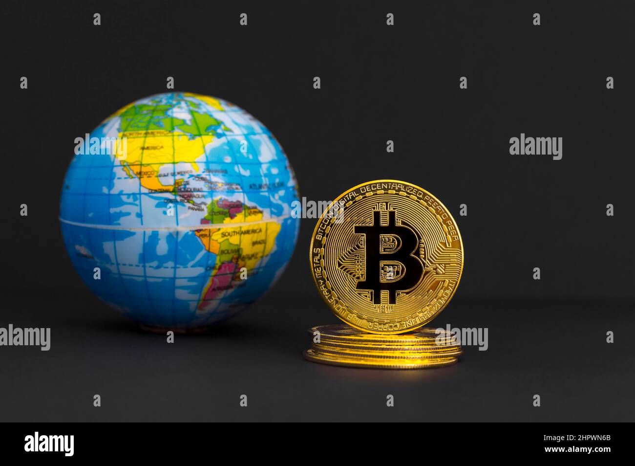 Bitcoin BTC crypto currency gold coin and Earth globe, worldwide new virtual money concept ...