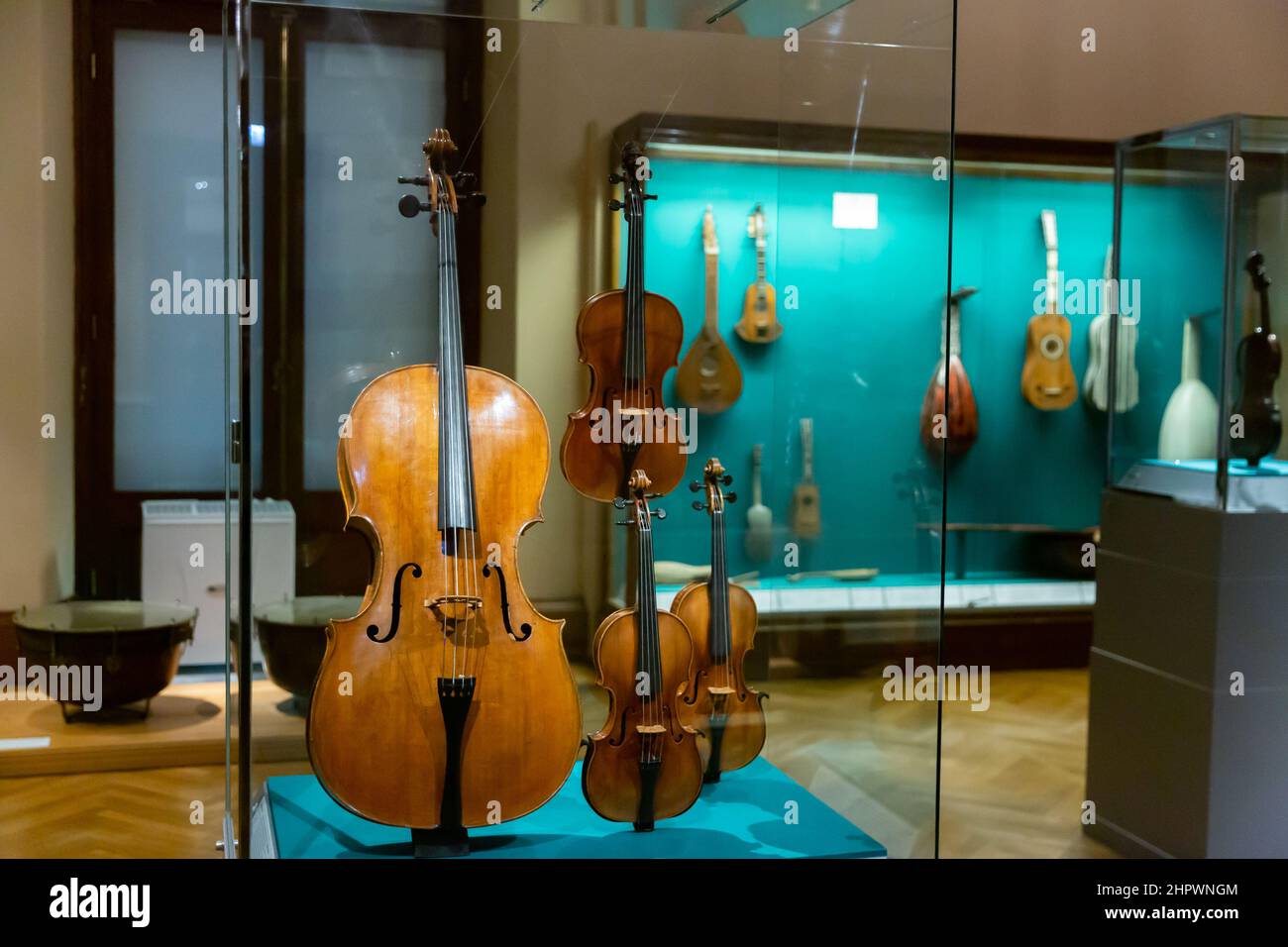 Showcase with bowed string instruments in Weltmuseum Wien, Austria ...