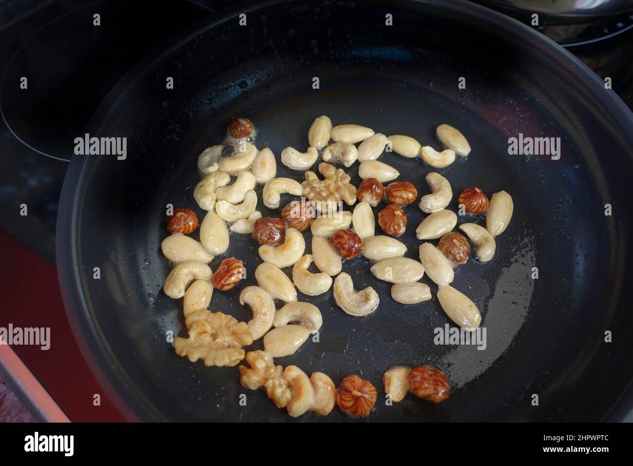Swabian cuisine, preparation French Toast, fry nuts in pan, caramelise ...