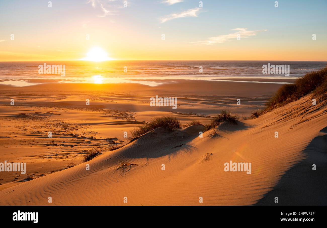 Sunset over the sea, sandy beach with sand dunes on the coast, Alder ...